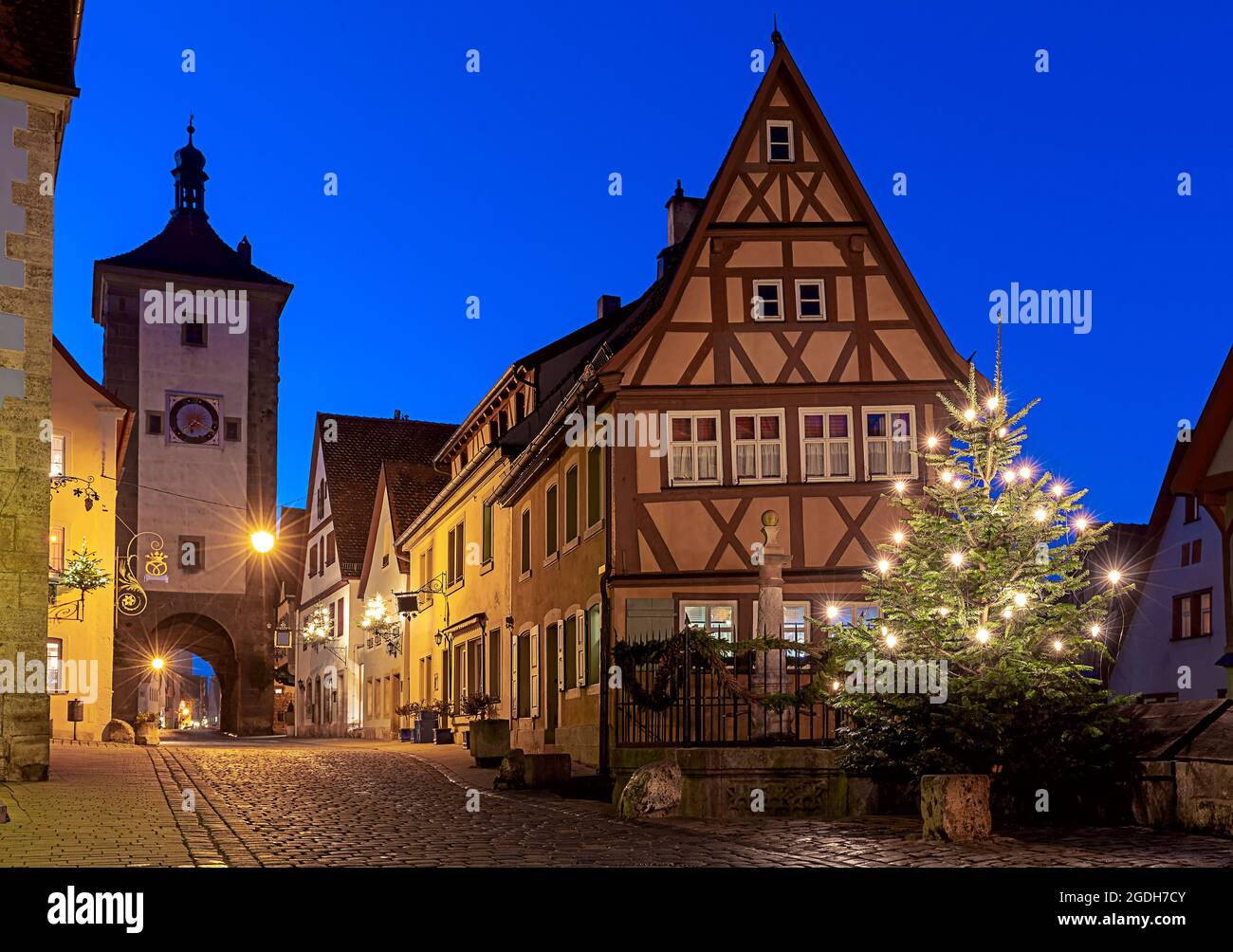 Old traditional medieval street in night illumination. Rothenburg ob ...