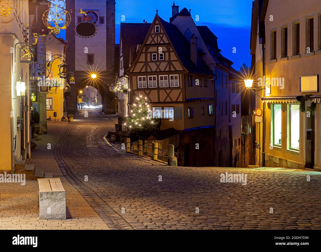 Old traditional medieval street in night illumination. Rothenburg ob ...