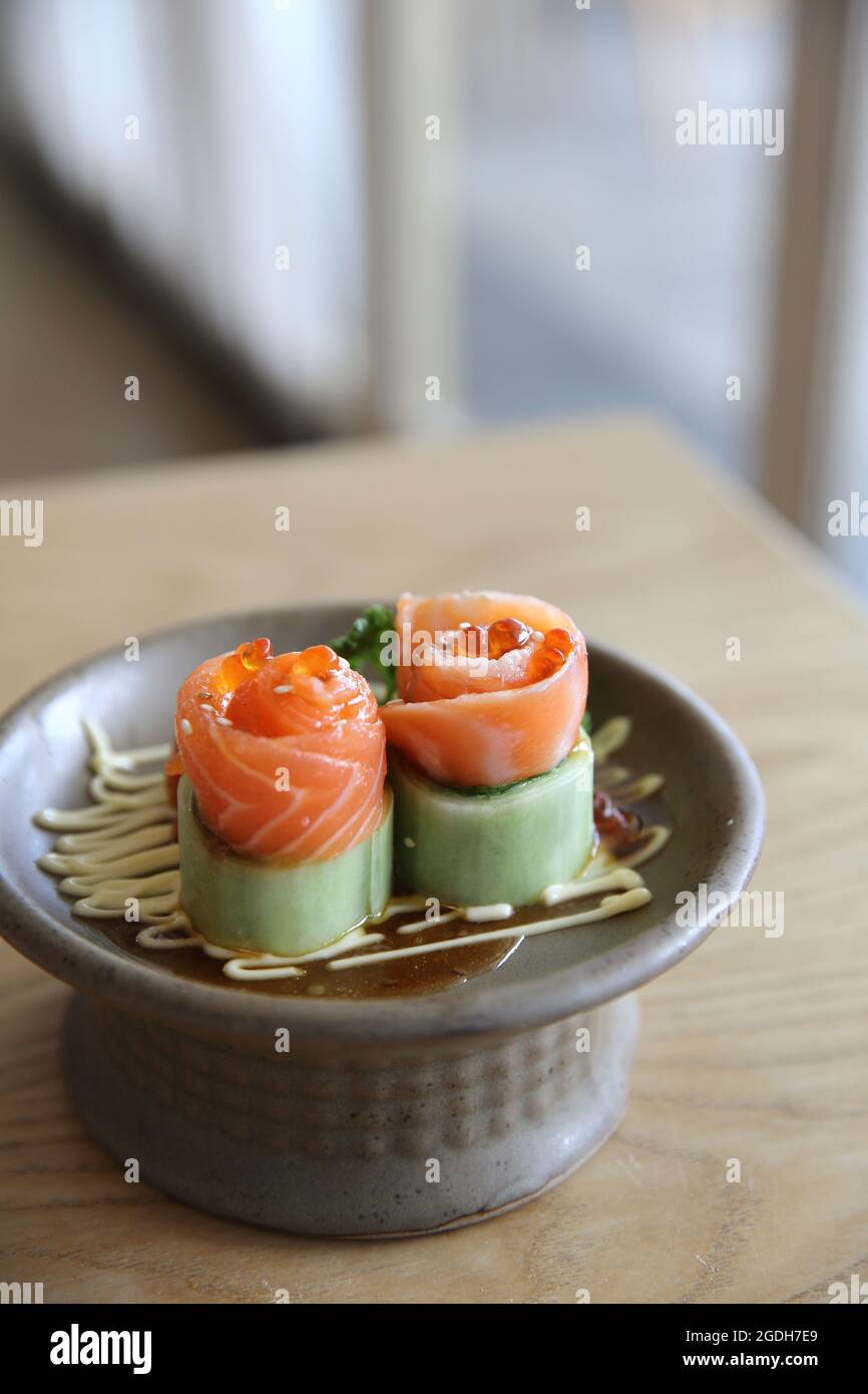 Salmon sashimi with cucumber on wood Stock Photo - Alamy