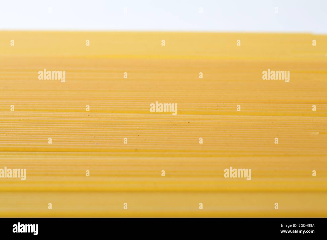 Raw spaghetti noodle isolated in white background Stock Photo - Alamy