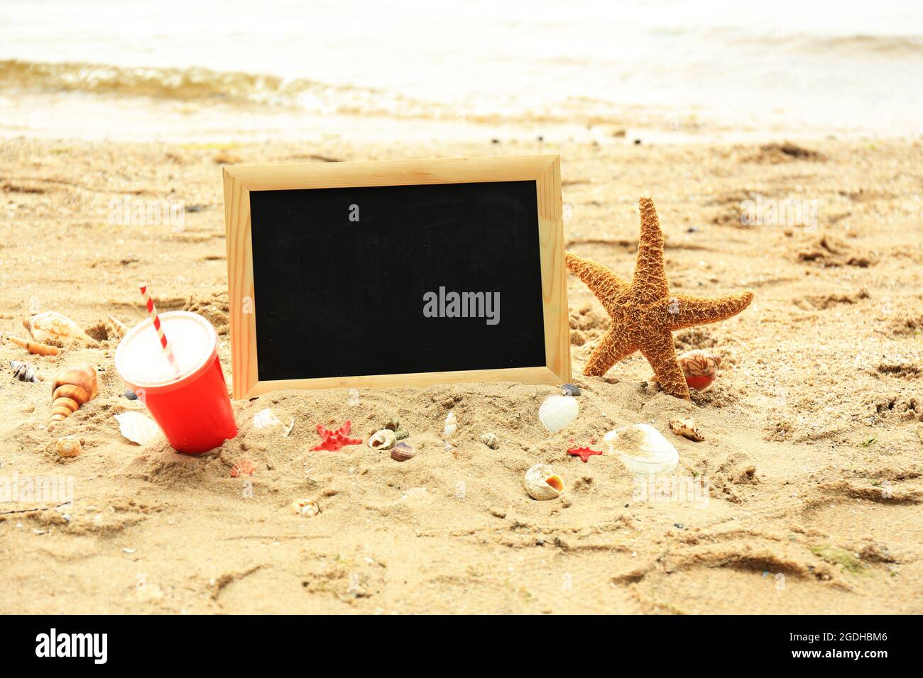 Blank chalkboard on beach background Stock Photo - Alamy