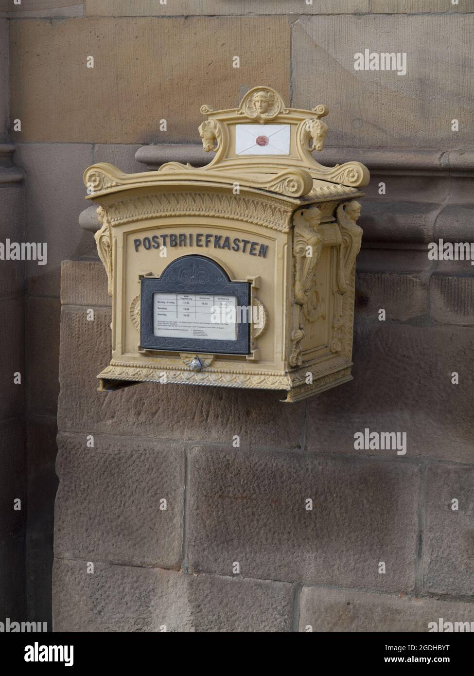 Vintage postal mail box on a brick wall on a cloudy day Stock Photo - Alamy