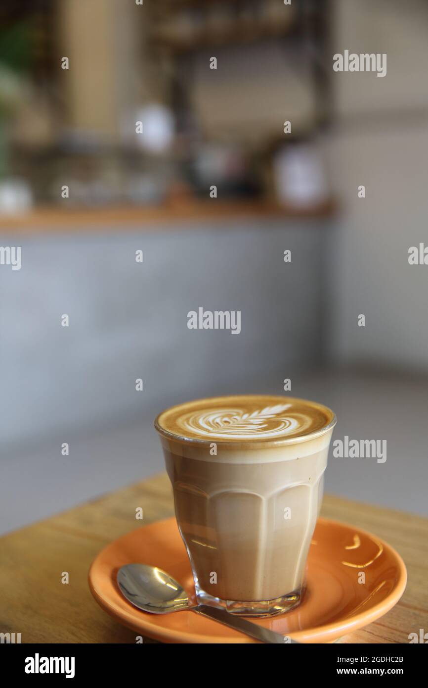 Cappuccino coffee on wood background in coffee shop Stock Photo - Alamy