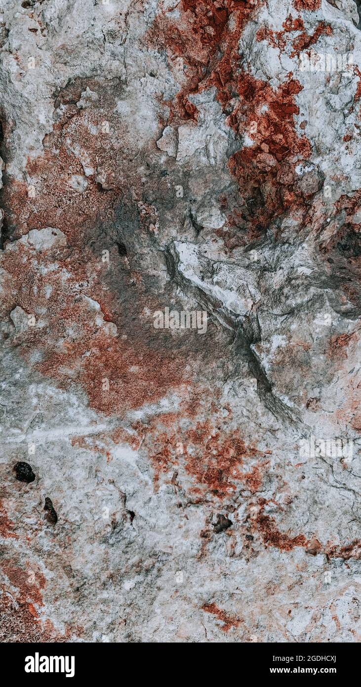 Vertical shot of a textured rock in gray and red colors Stock Photo - Alamy