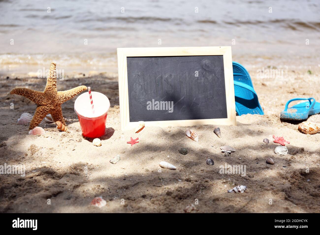Blank chalkboard on beach background Stock Photo - Alamy