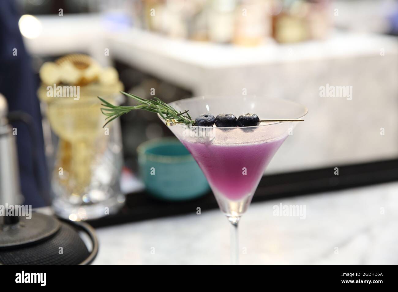 Purple cocktail on bar background Stock Photo - Alamy