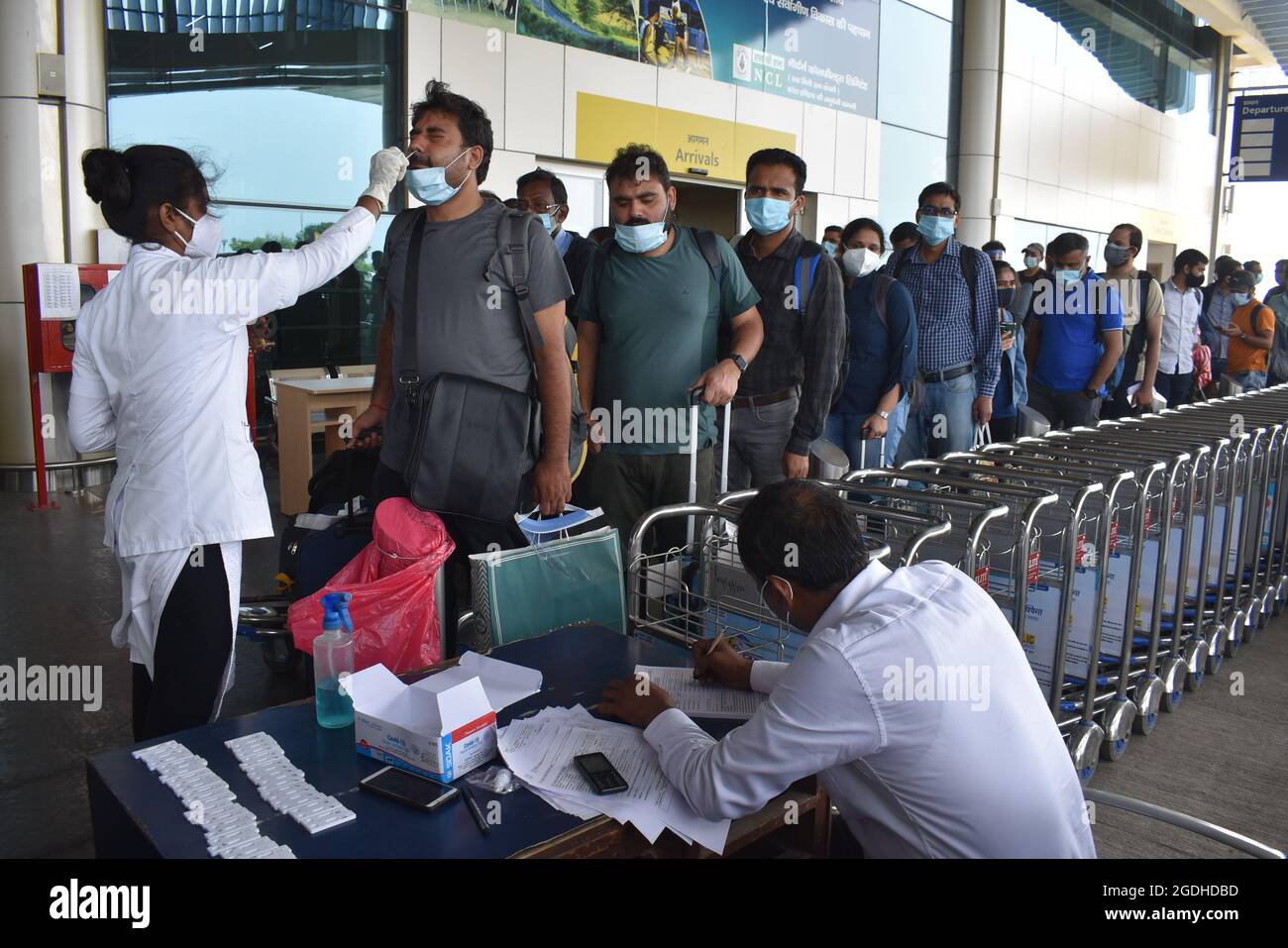 Prayagraj, India. 13th Aug, 2021. A health worker takes a nasal swab ...