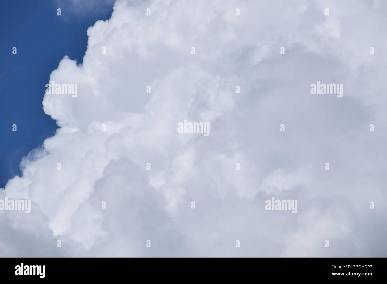 Fluffy white clouds in a blue sky Stock Photo - Alamy