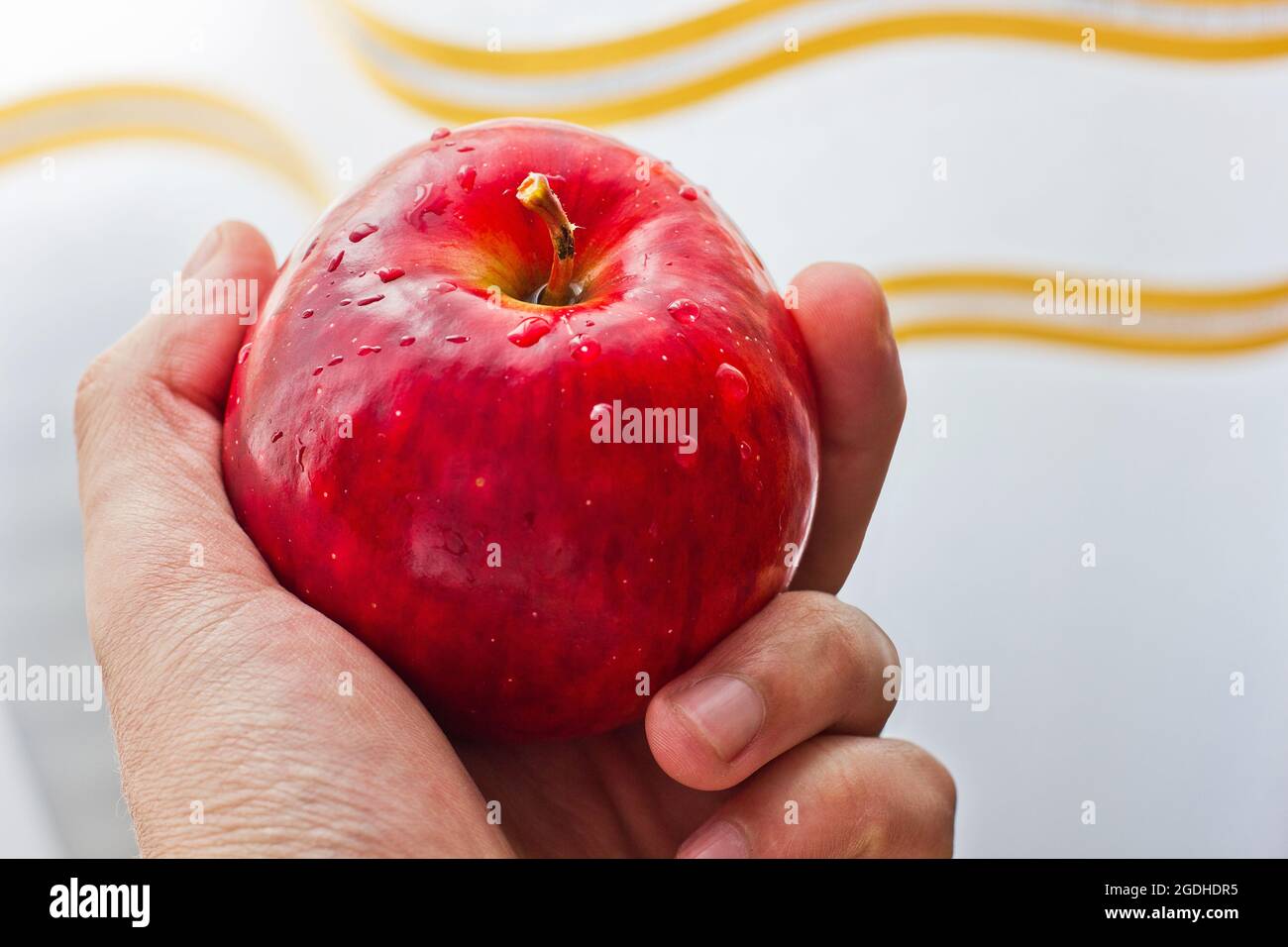Red apple in hand Stock Photo - Alamy