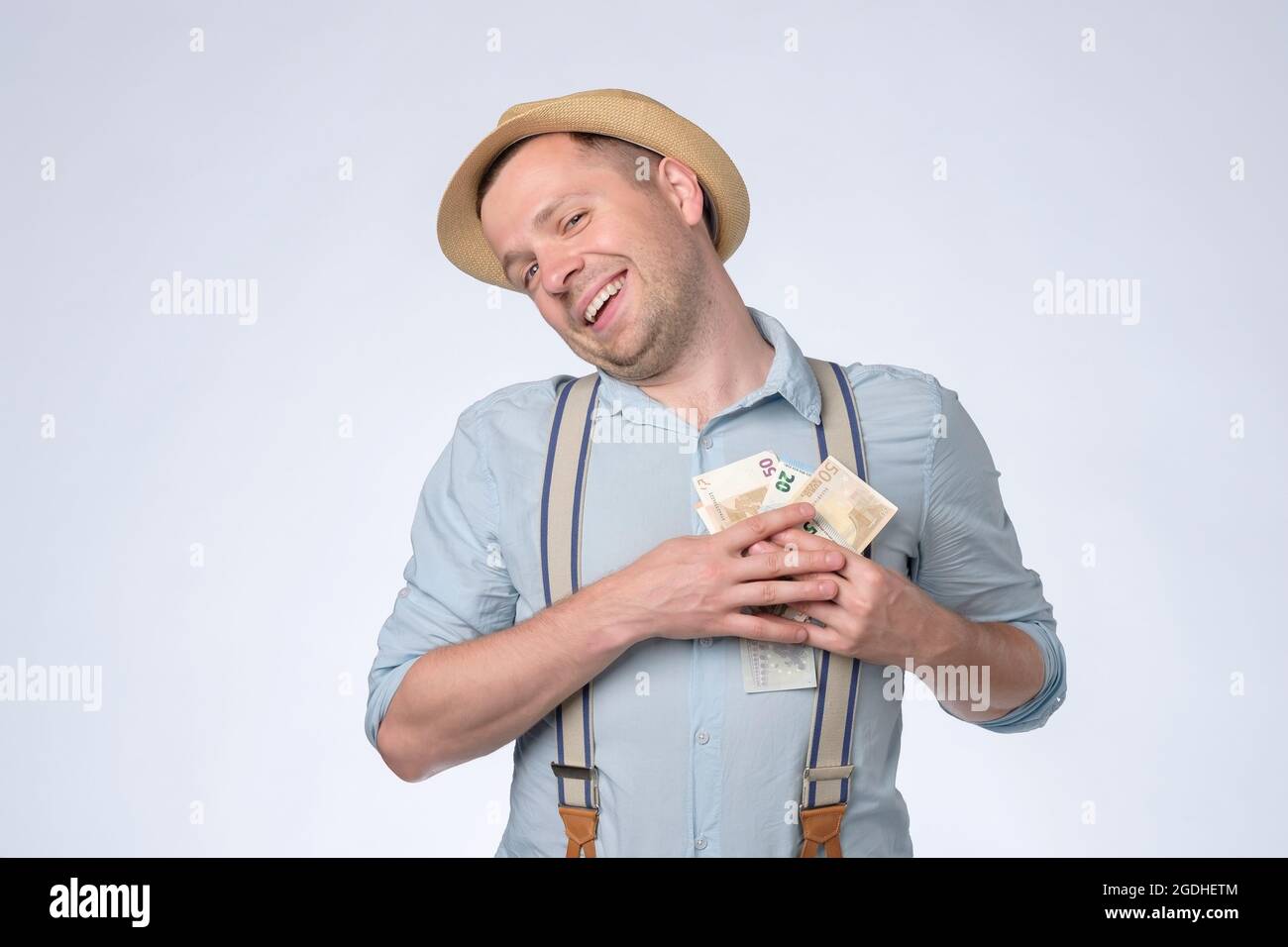 Man has money and he is satisfied. Guy is hugging euro cash feeling ...