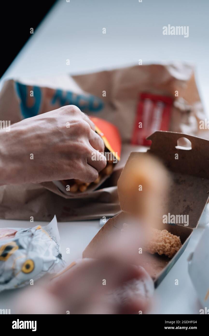 Hand taking fries hi-res stock photography and images - Alamy