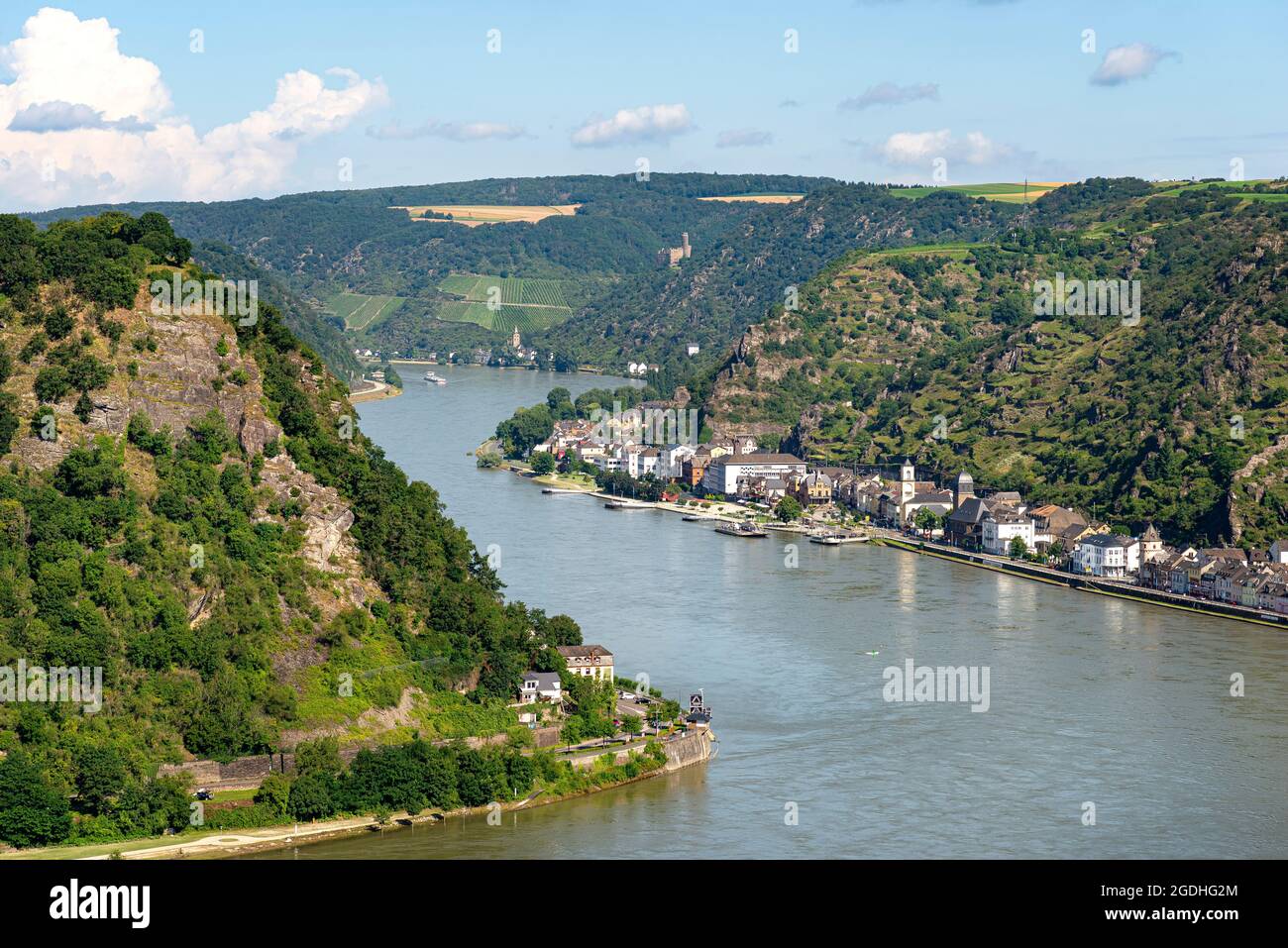 The river Rhine in western Germany flows between the hills covered with ...