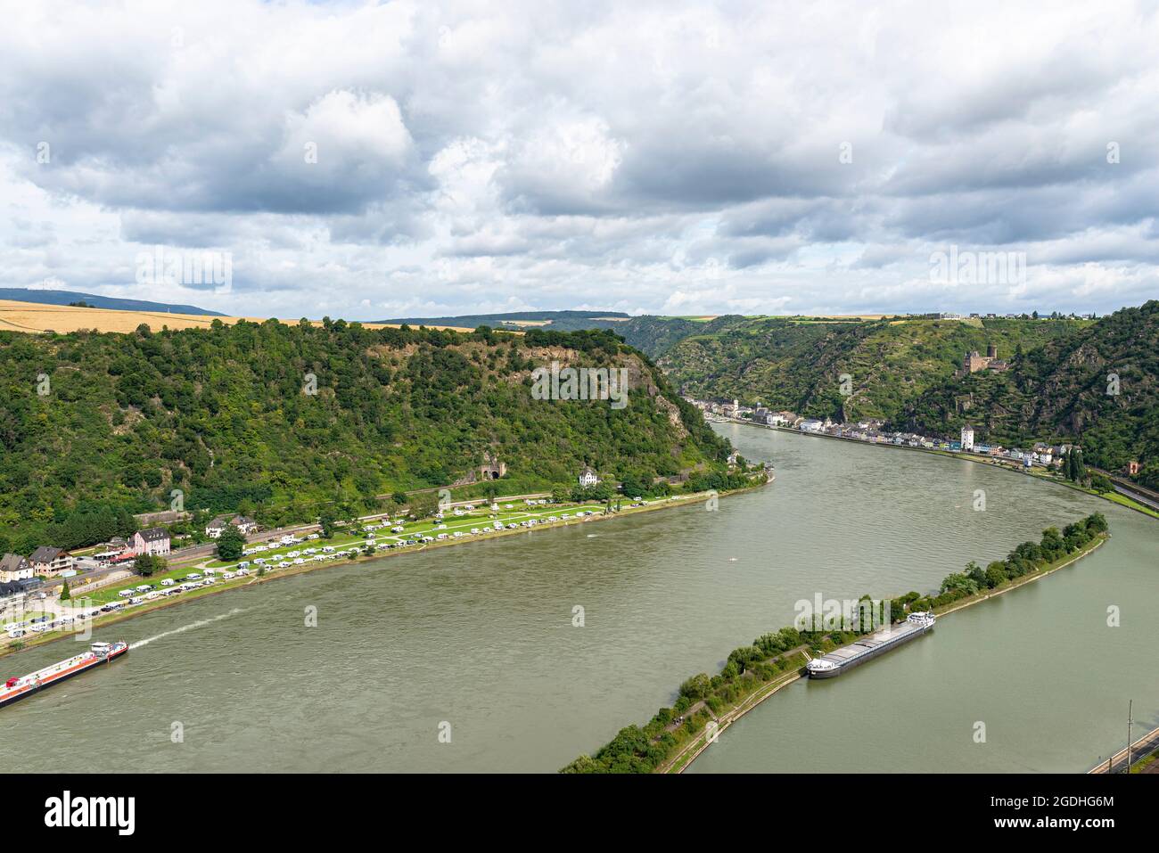 The river Rhine in western Germany flows between the hills covered with ...