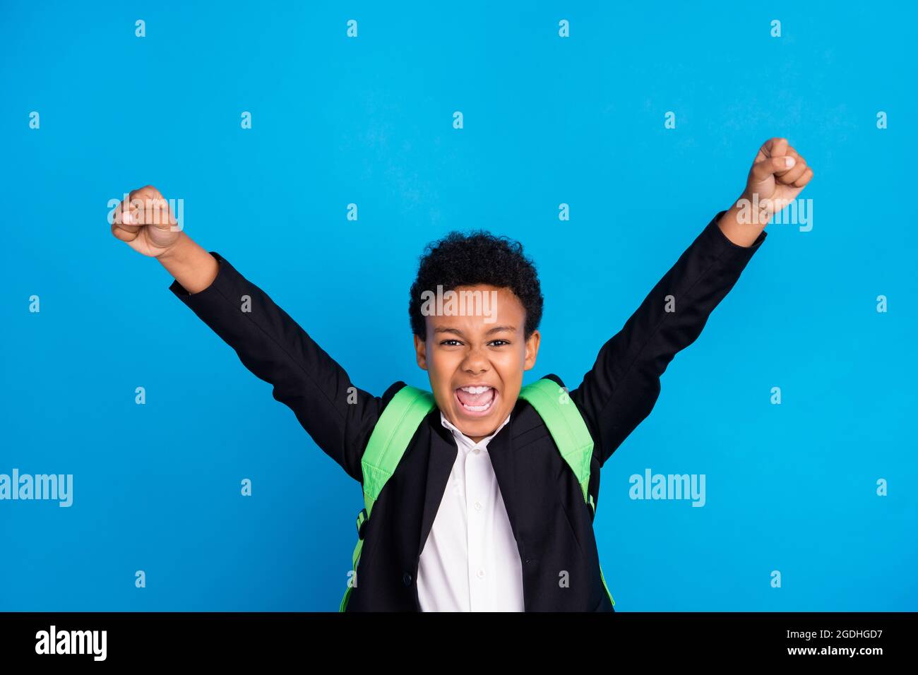 Photo of cheerful young happy positive boy raise fists winner good mood ...
