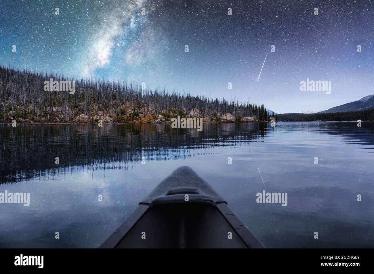 Canoeing with milky way and shooting star reflection on Maligne lake at ...