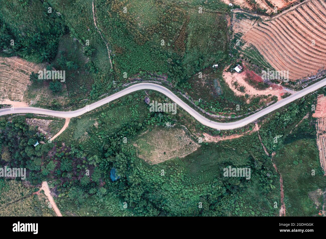 Top view of curved asphalt road on hill in the forest at countryside ...
