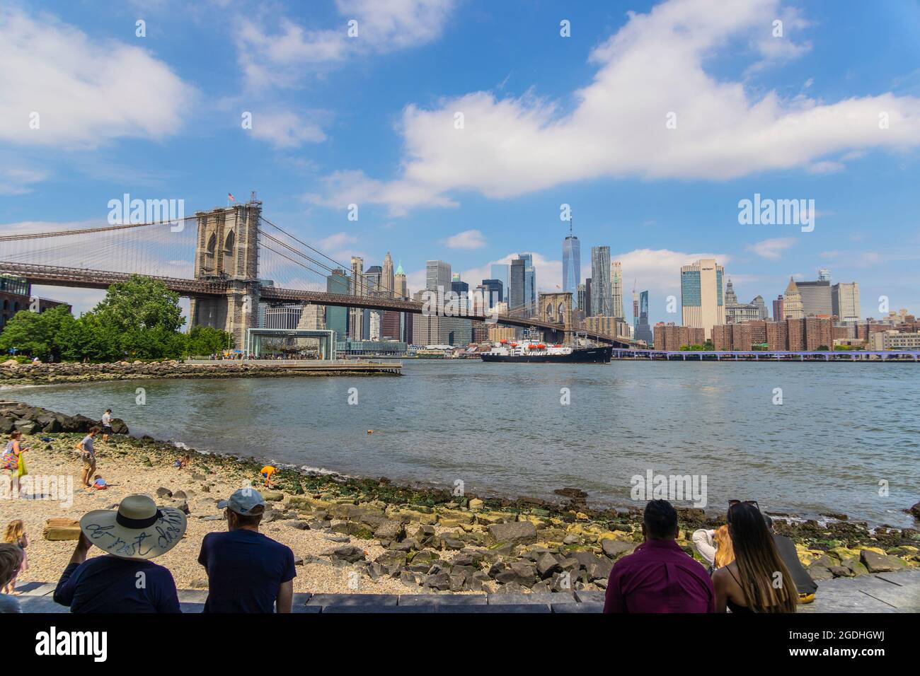 People enjoy time with friends on the Beach of Brooklyn Bridge Park ...