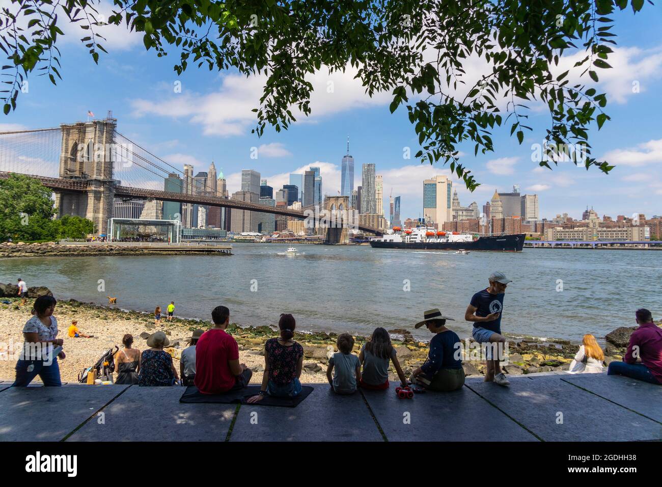 People enjoy time with friends on the Beach of Brooklyn Bridge Park ...