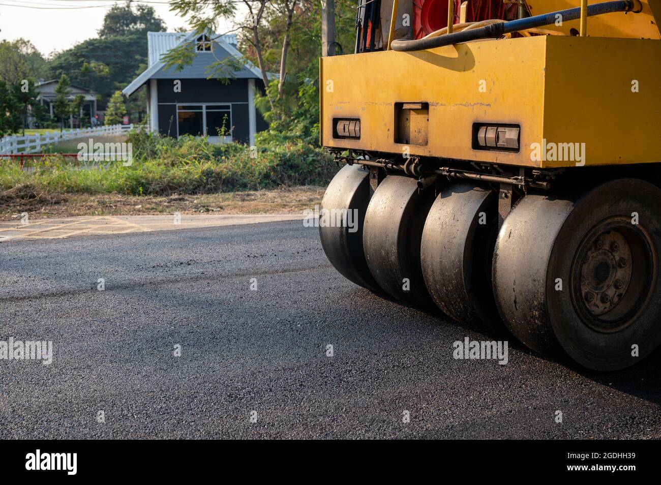 Heavy vibration yellow steamroller or soil compactor working on hot-mix ...