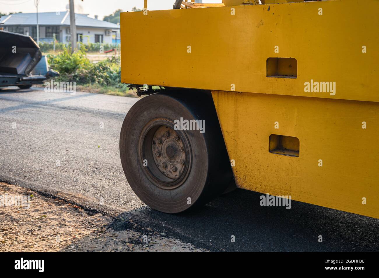 Heavy vibration yellow steamroller or soil compactor working on hot-mix ...