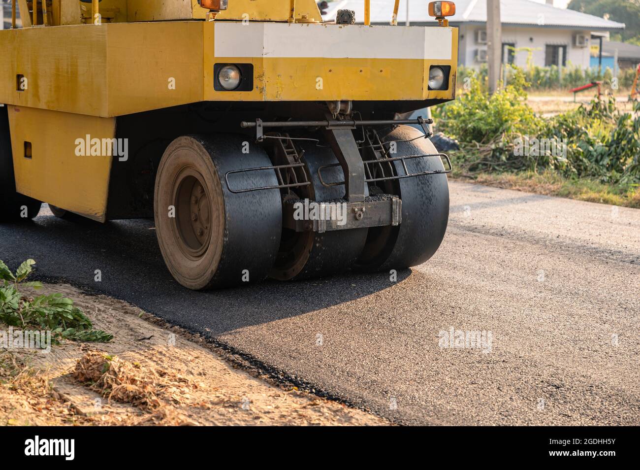 Heavy vibration yellow steamroller or soil compactor working on hot-mix ...