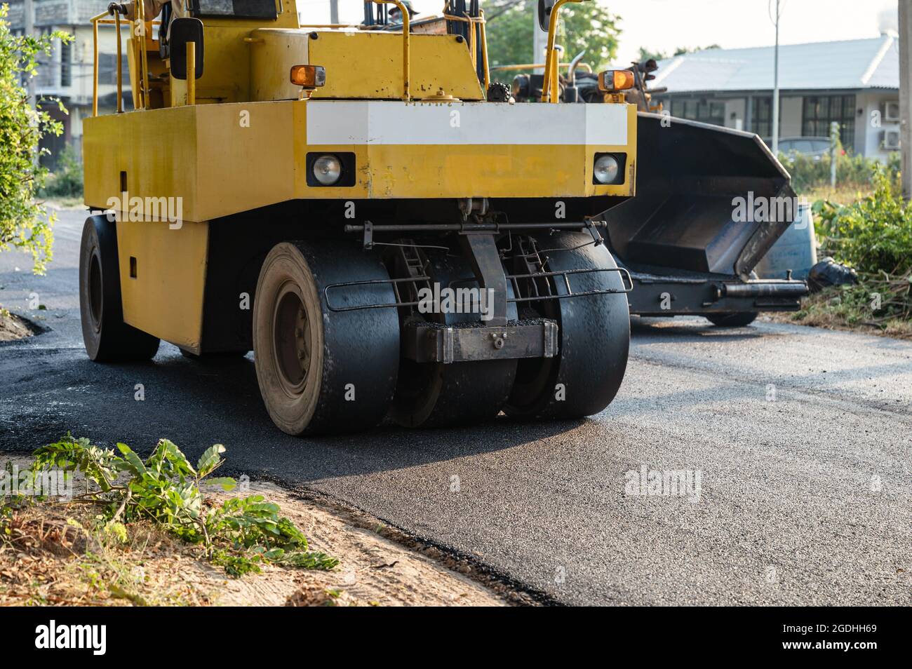 Heavy vibration yellow steamroller or soil compactor working on hot-mix ...