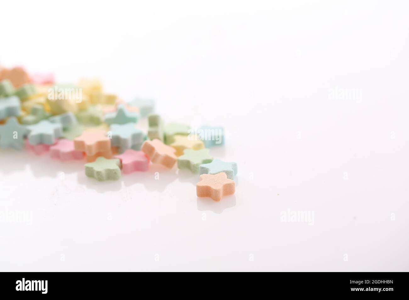 Colourful Star Milk pellets isolated in white background Stock Photo ...