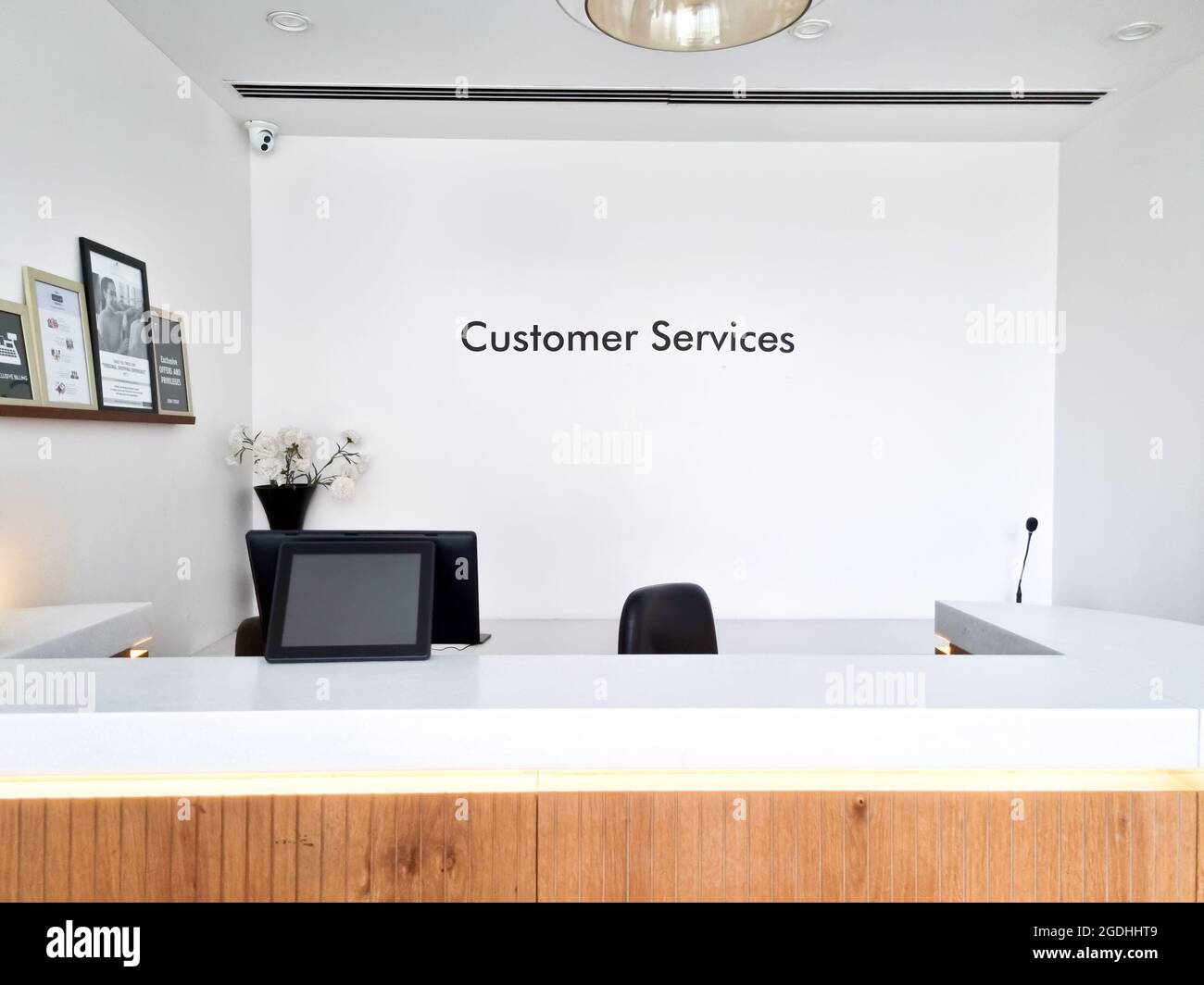 empty customer service alterations desk with chair phone and white ...
