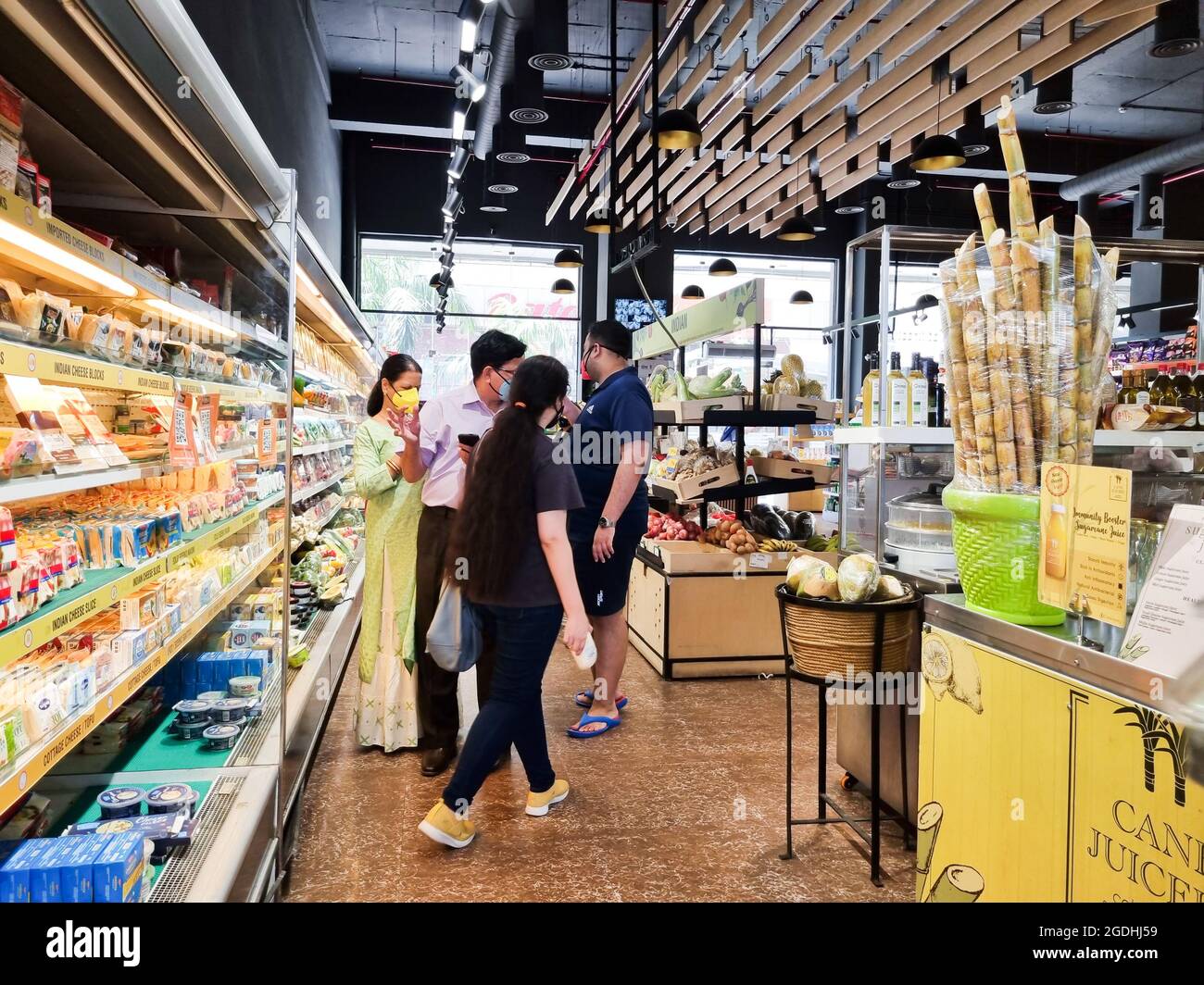 Young indian woman men and other people shopping for food in the ...