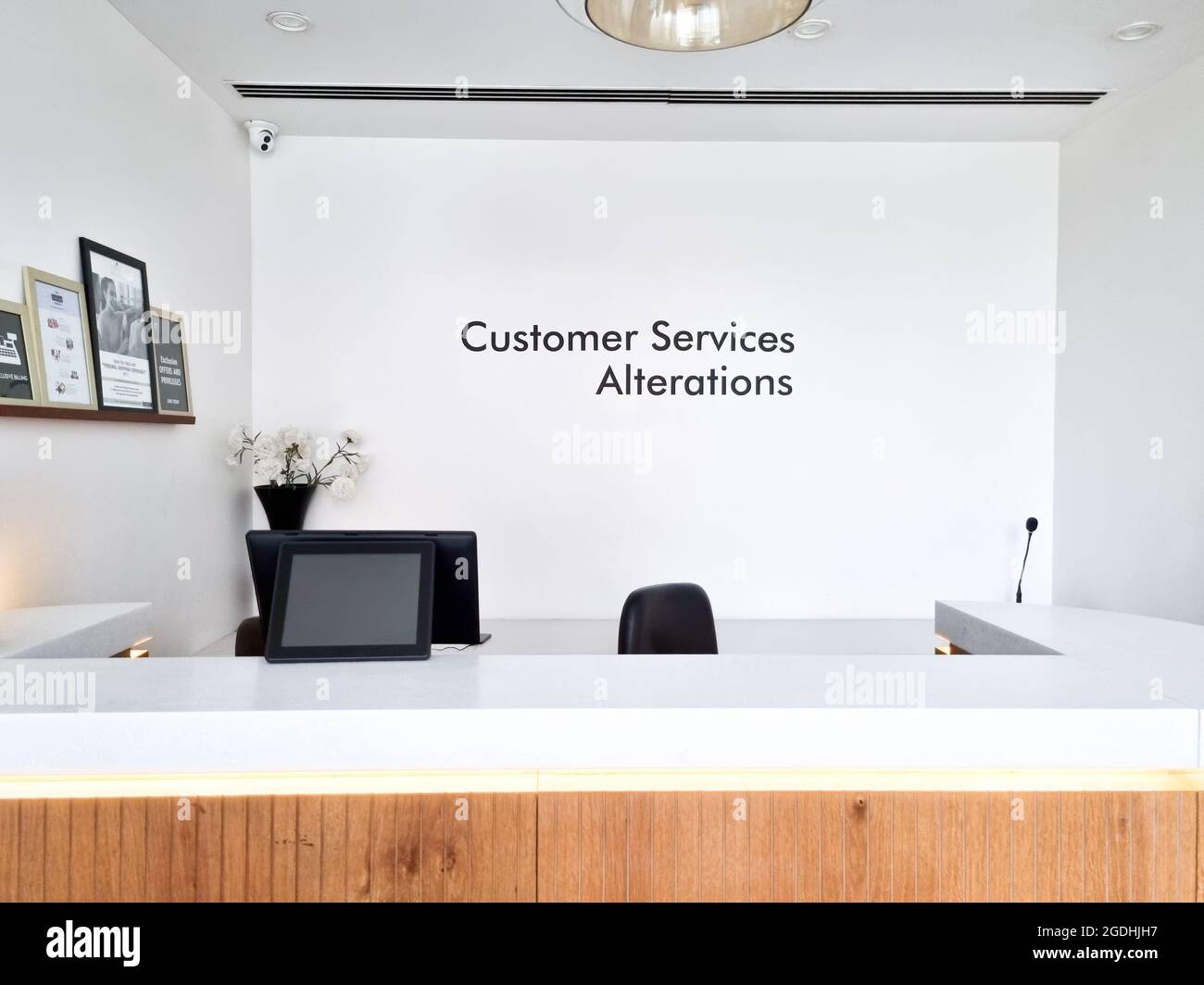 empty customer service alterations desk with chair phone and white ...
