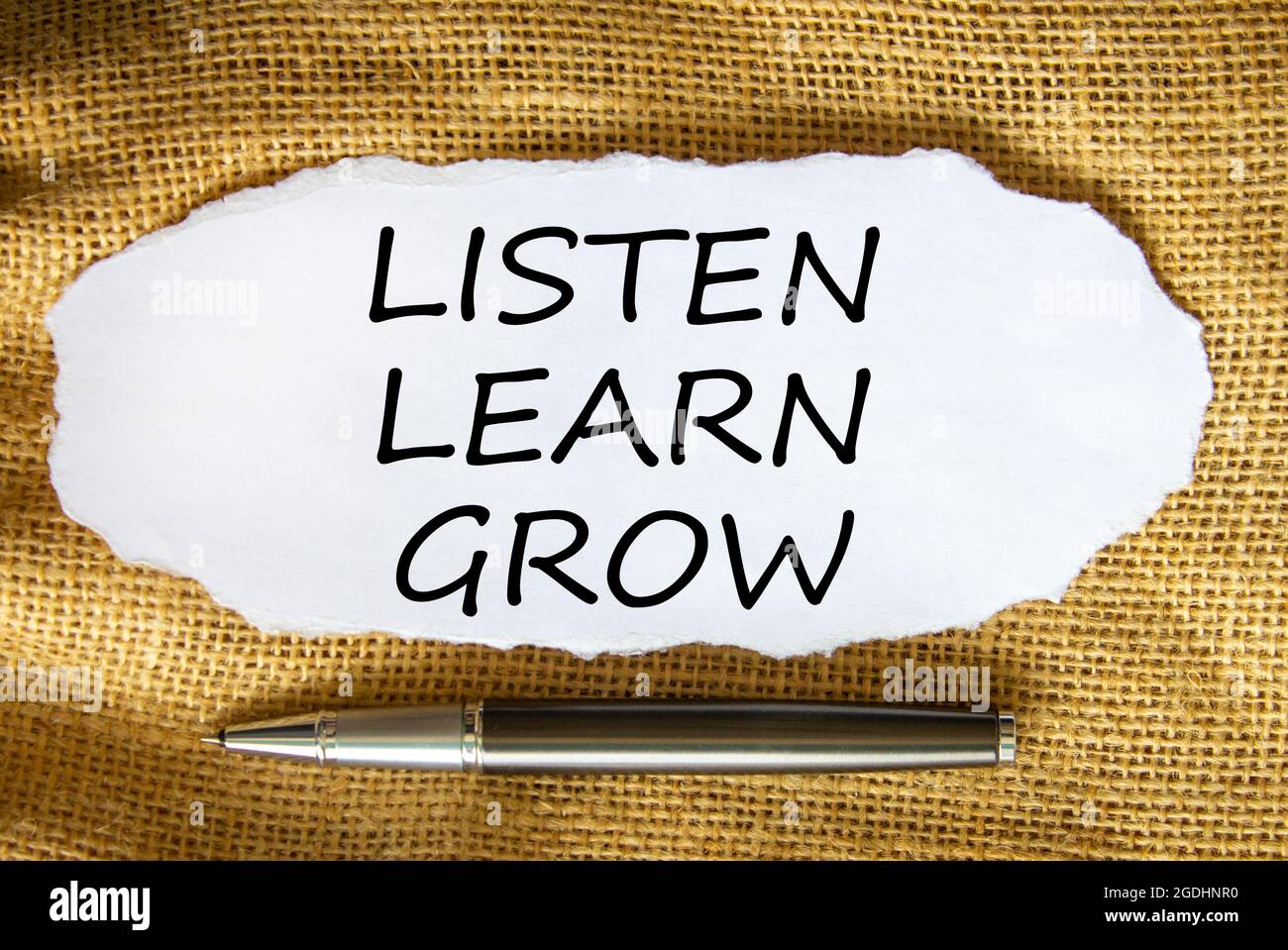 Listen, learn, grow symbol. Words 'Listen, learn, grow' on white paper ...