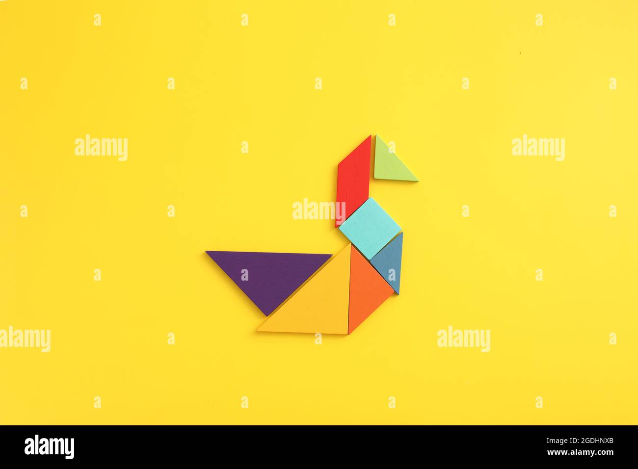 Wooden blocks duck isolated in yellow background Stock Photo - Alamy