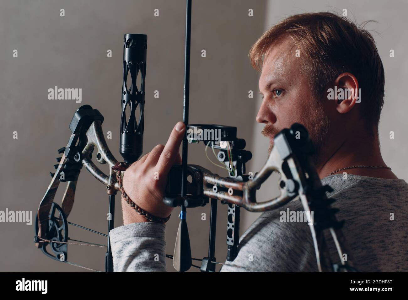 Archer man with modern block sport bow and arrow Stock Photo - Alamy