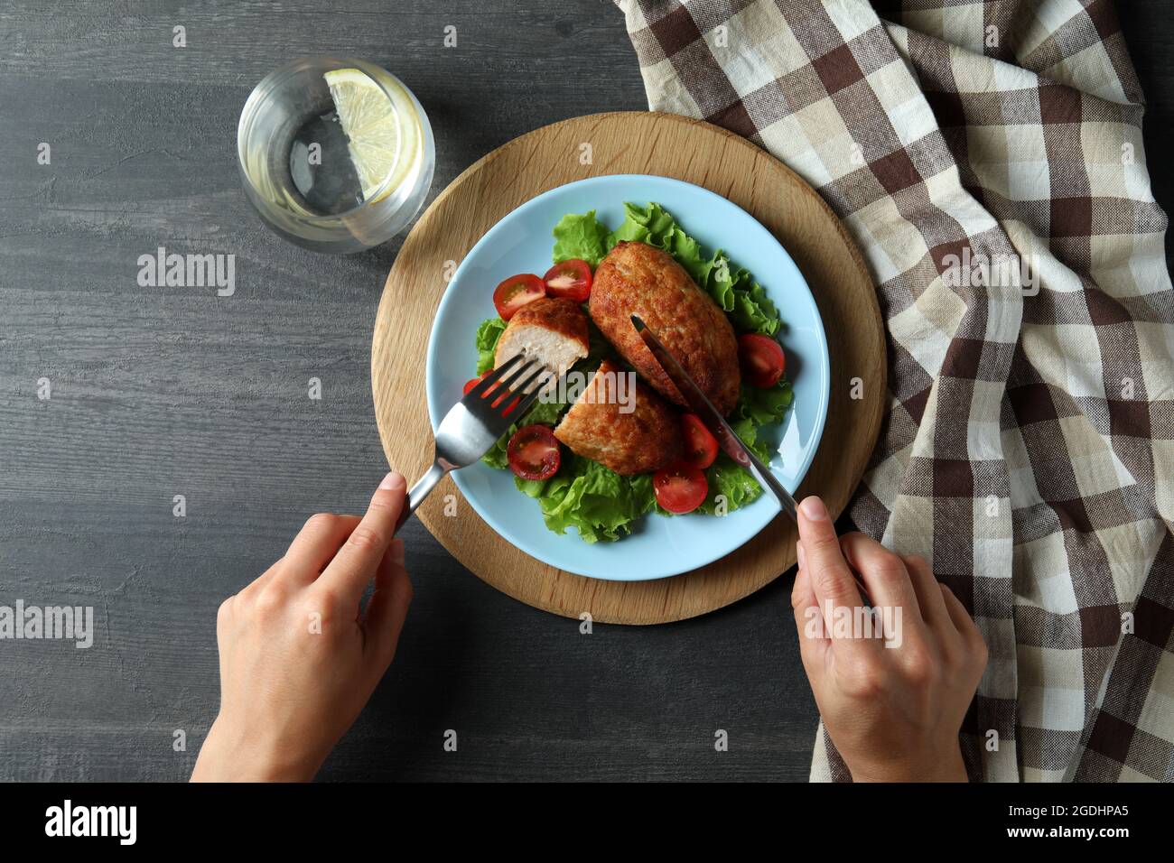 Concept of tasty eating with cutlets on dark wooden table Stock Photo ...