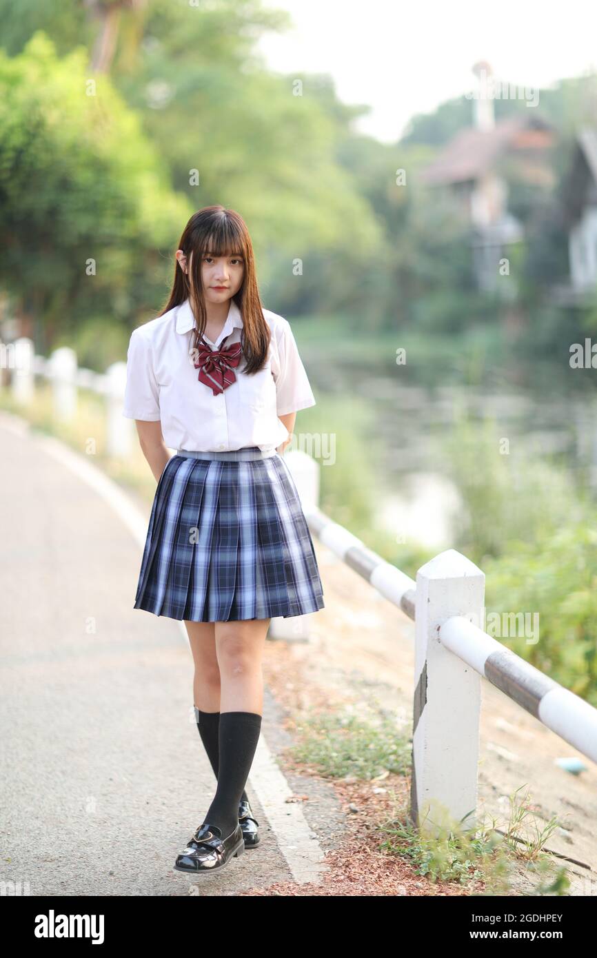 beautiful asian japanese school girl uniform looking at park outdoor Stock Photo - Alamy