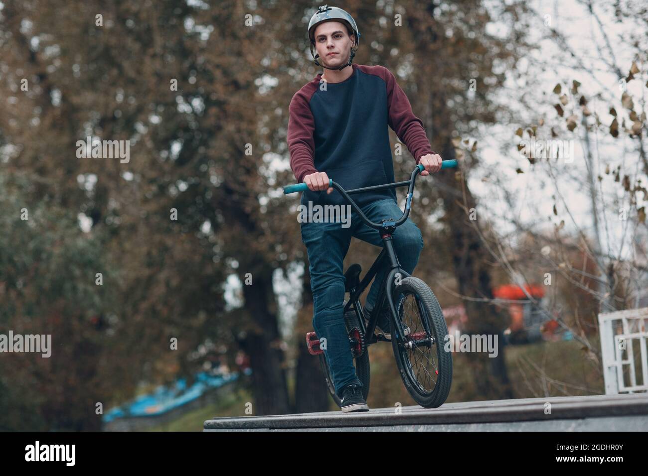 Professional young sportsman cyclist riding mini bike at skatepark ...