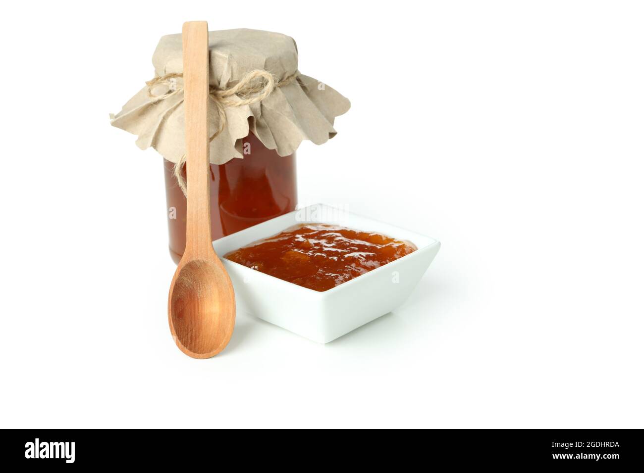 Jar and bowl of peach jam, and spoon isolated on white background Stock ...