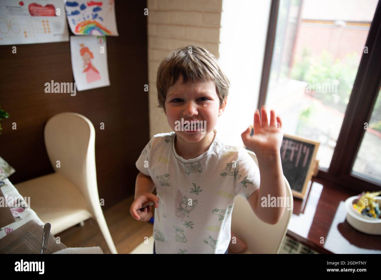 young boy cries at the table Stock Photo - Alamy
