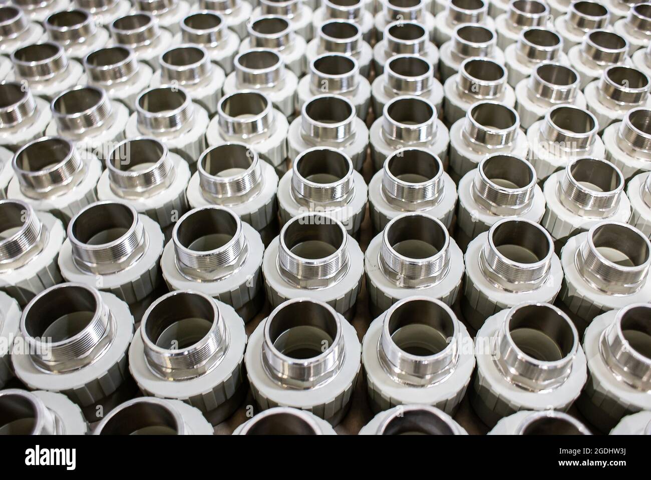 many metal pipe couplings in a pipe factory Stock Photo - Alamy