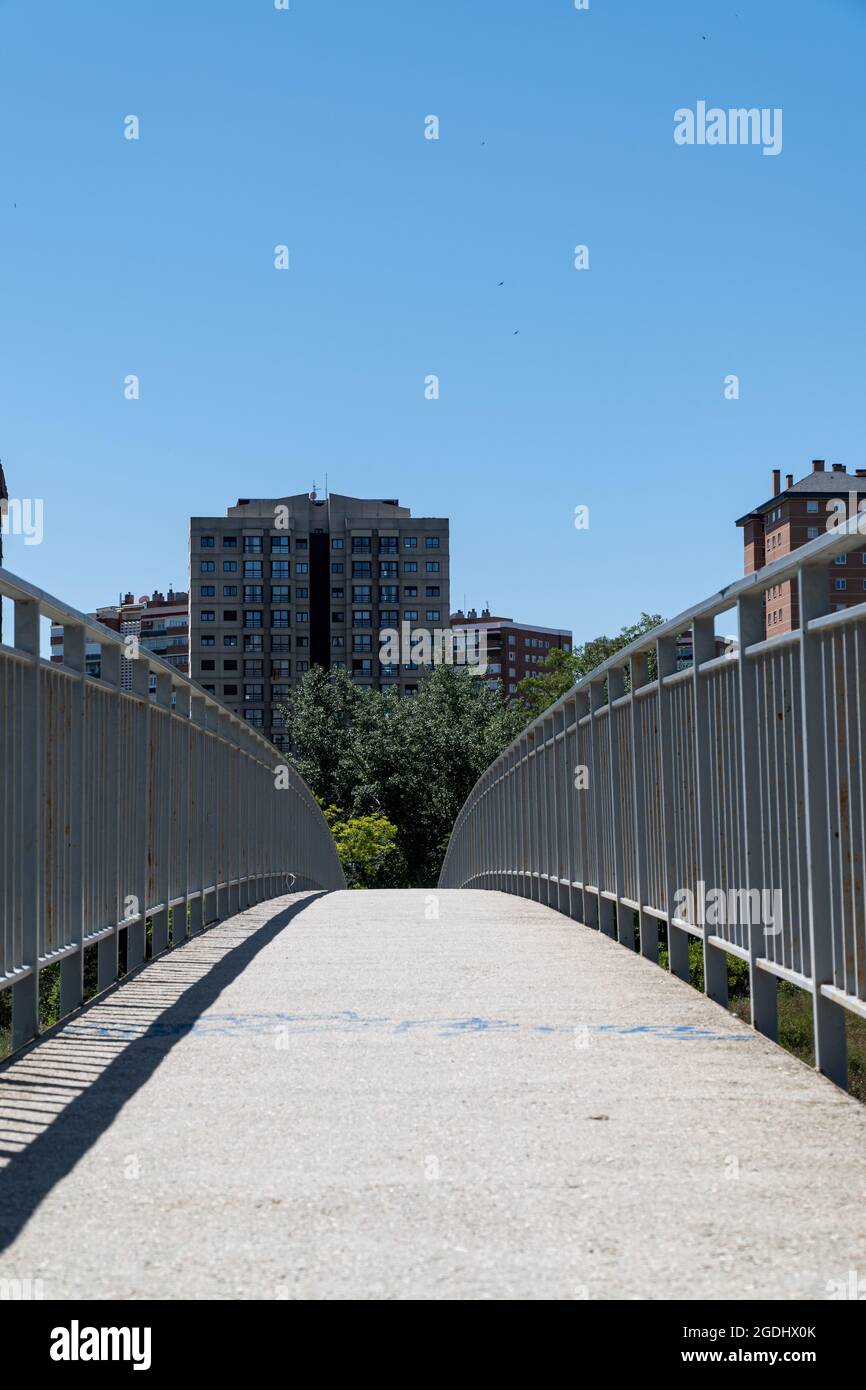 footbridge over a highway bridge to a residential area of buildings ...