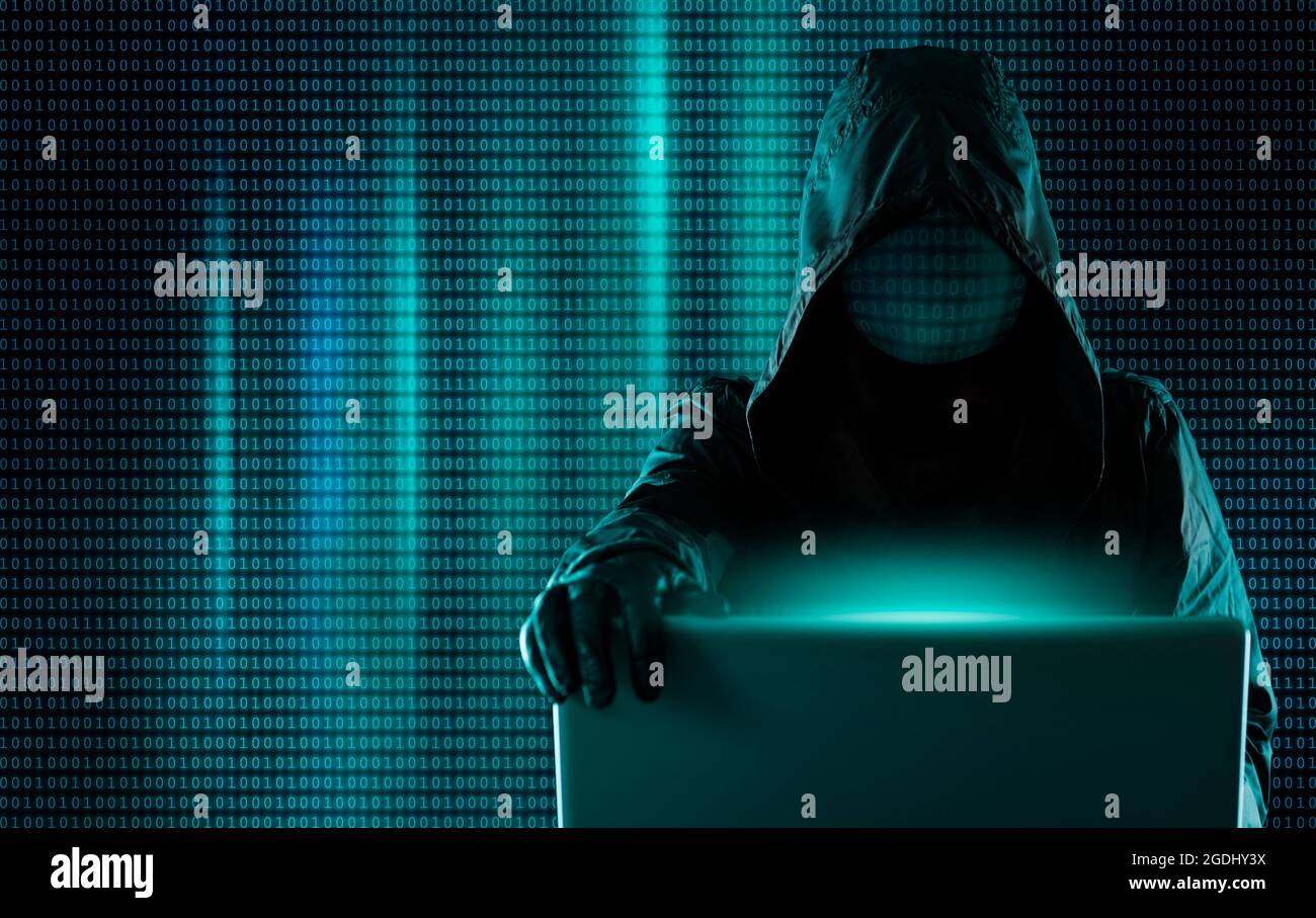 Hacking system, cybercriminal behind a laptop, digital binary code in ...