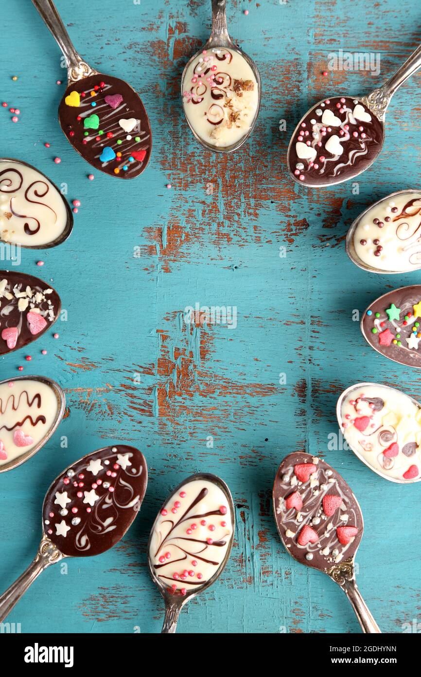 Spoons with tasty chocolate for party on old blue wooden table Stock ...