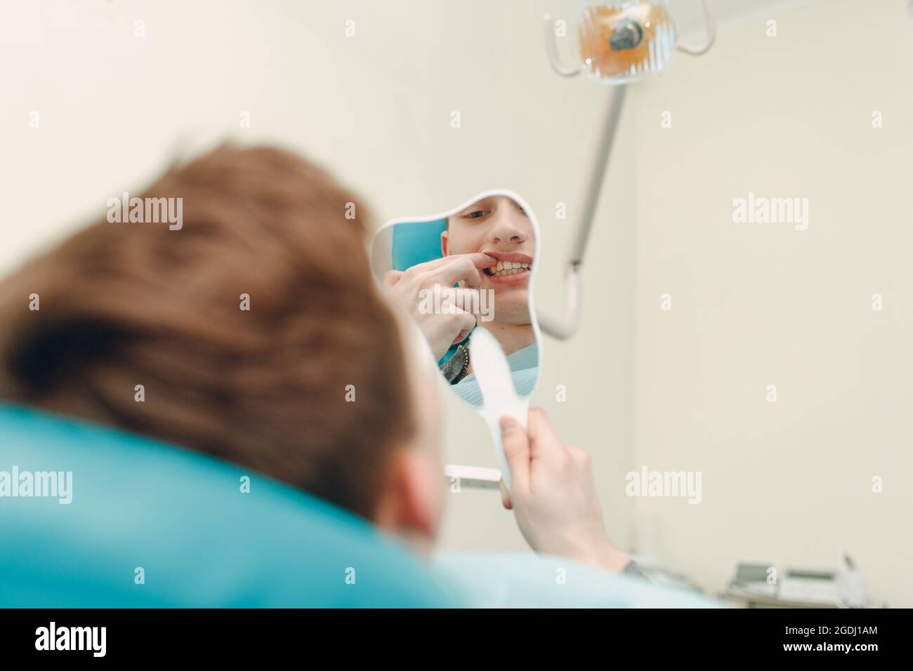 Dentistry. Dentist and patient. Dental clinic. Patient looking on smile ...