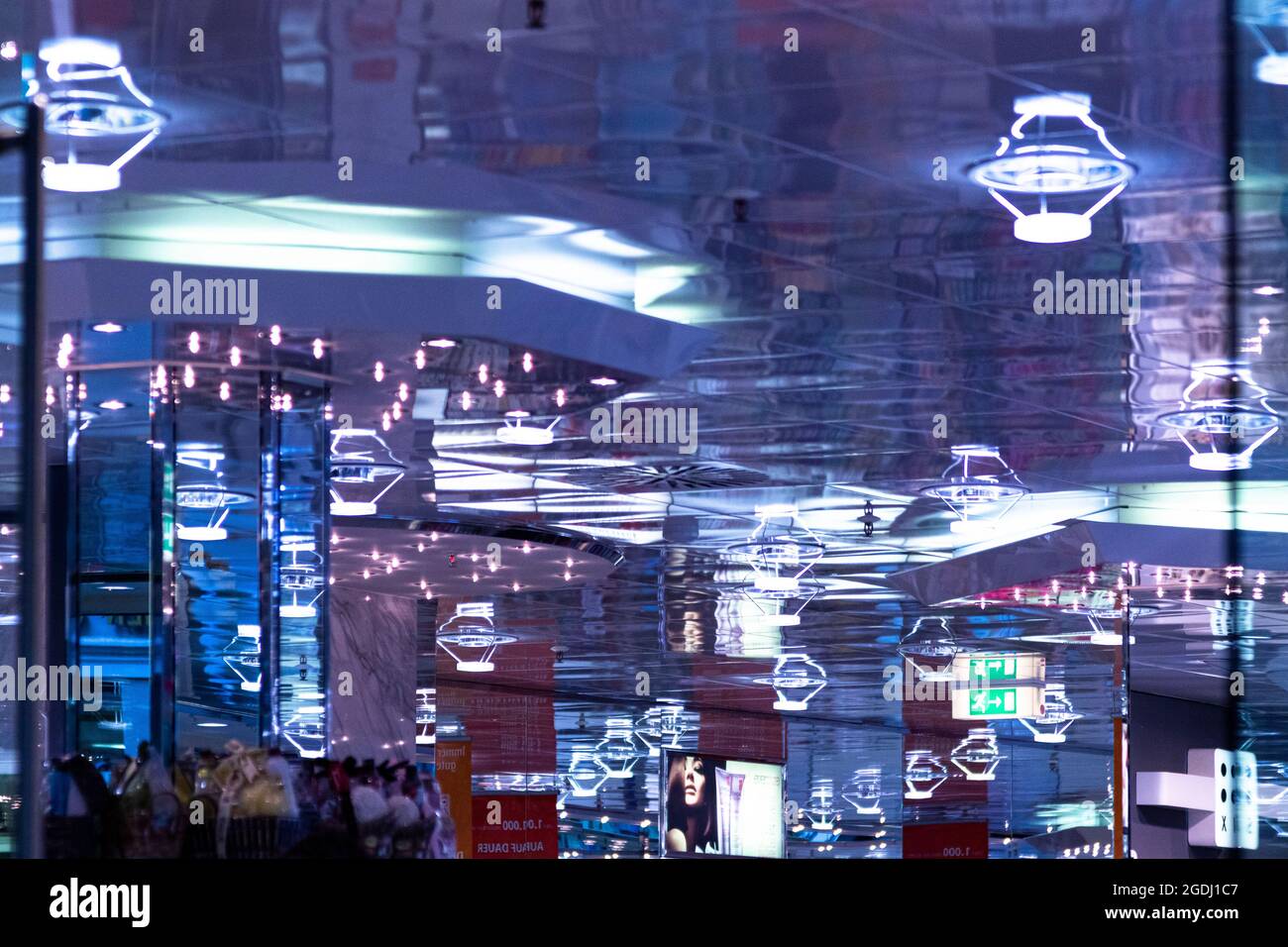 Ceiling lamps are reflected in glass, creating blue light with many ...