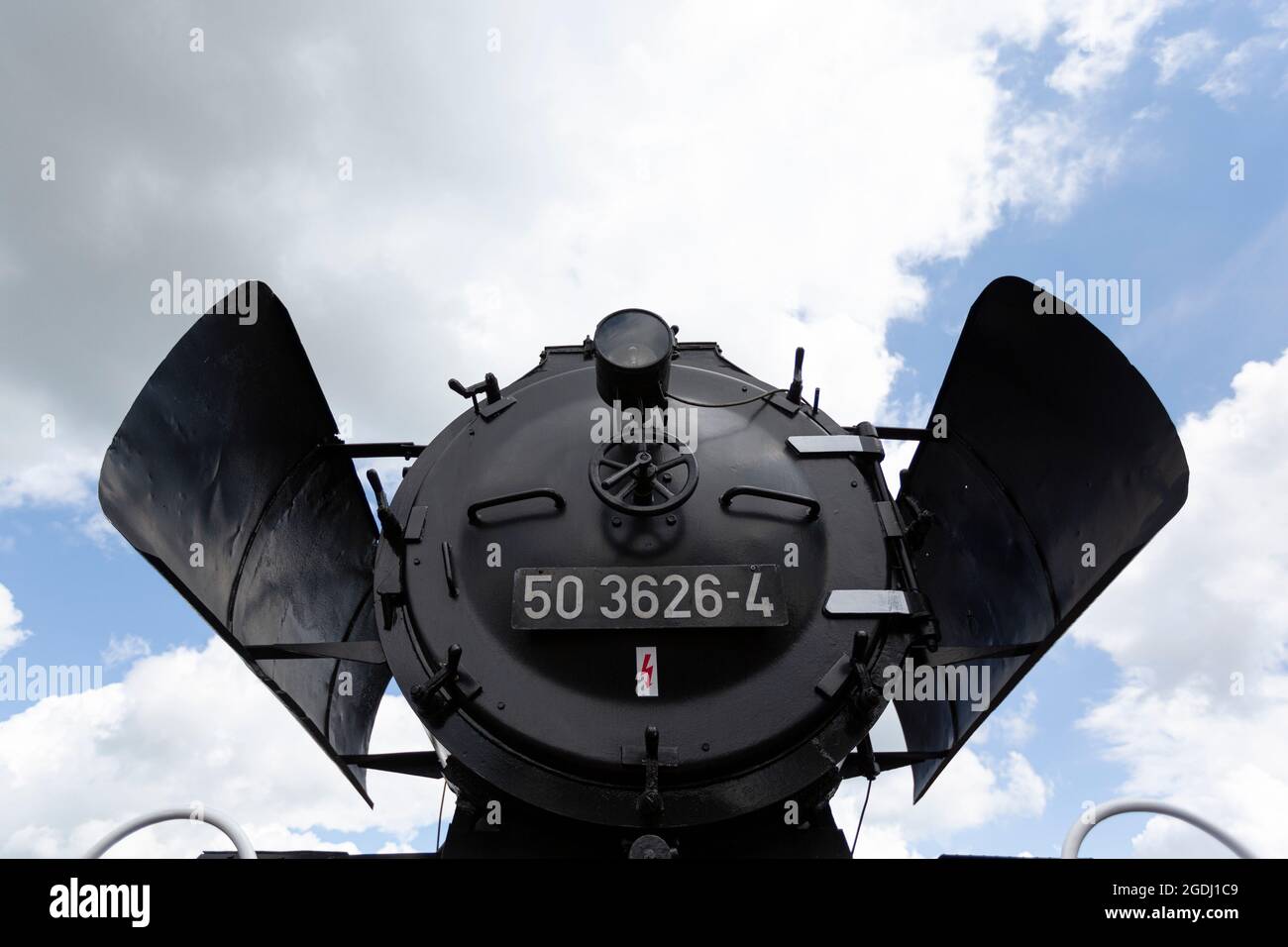 A historical steam locomotive was photographed from below against the ...