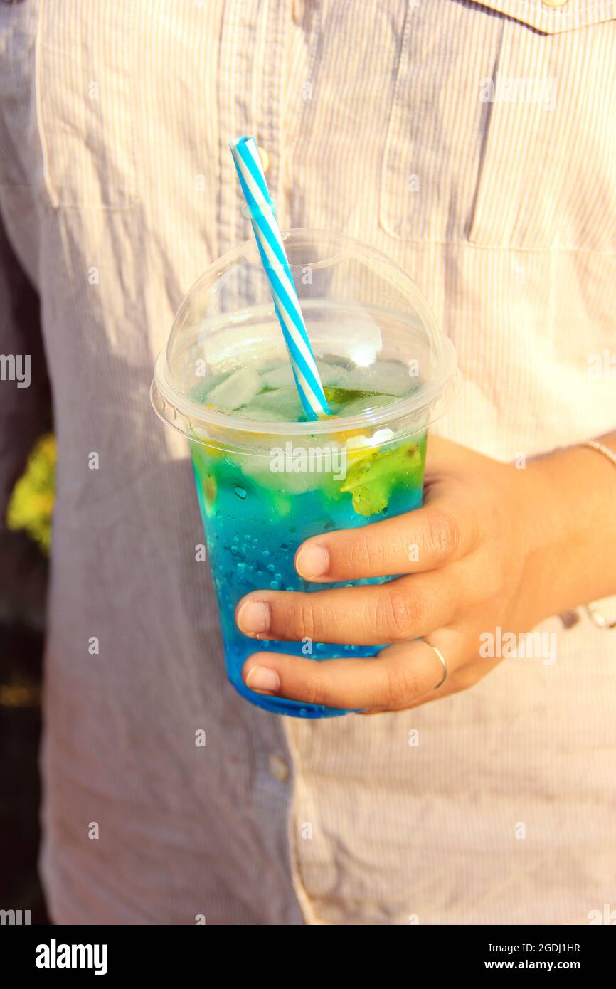 Cocktail in a girl's hand. Juicy drink in the hand Stock Photo - Alamy
