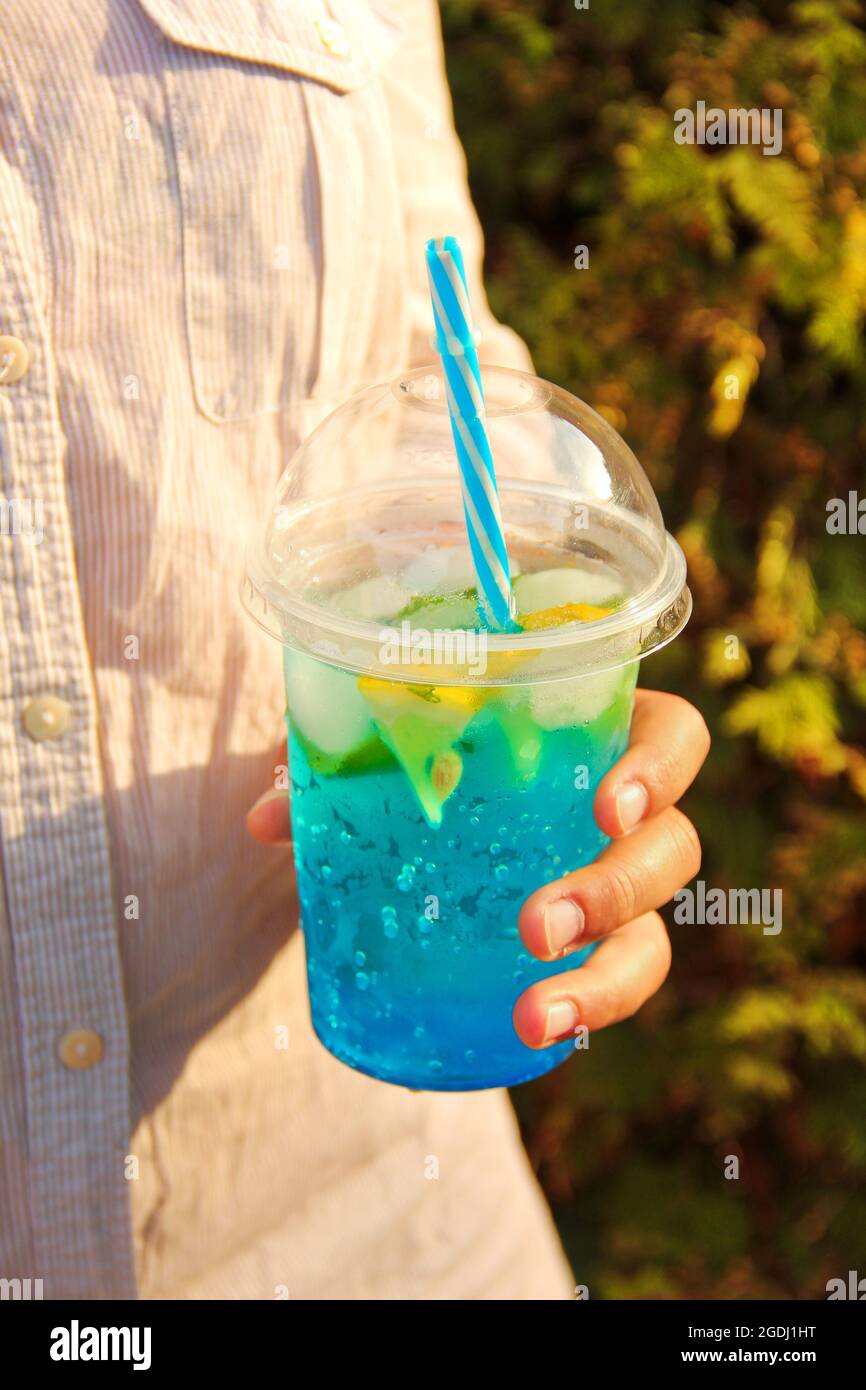 Cocktail in a girl's hand. Juicy drink in the hand Stock Photo - Alamy