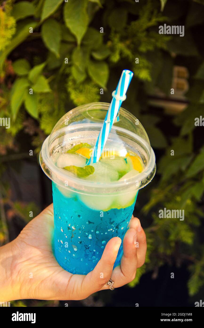 Cocktail in a girl's hand. Juicy drink in the hand Stock Photo - Alamy