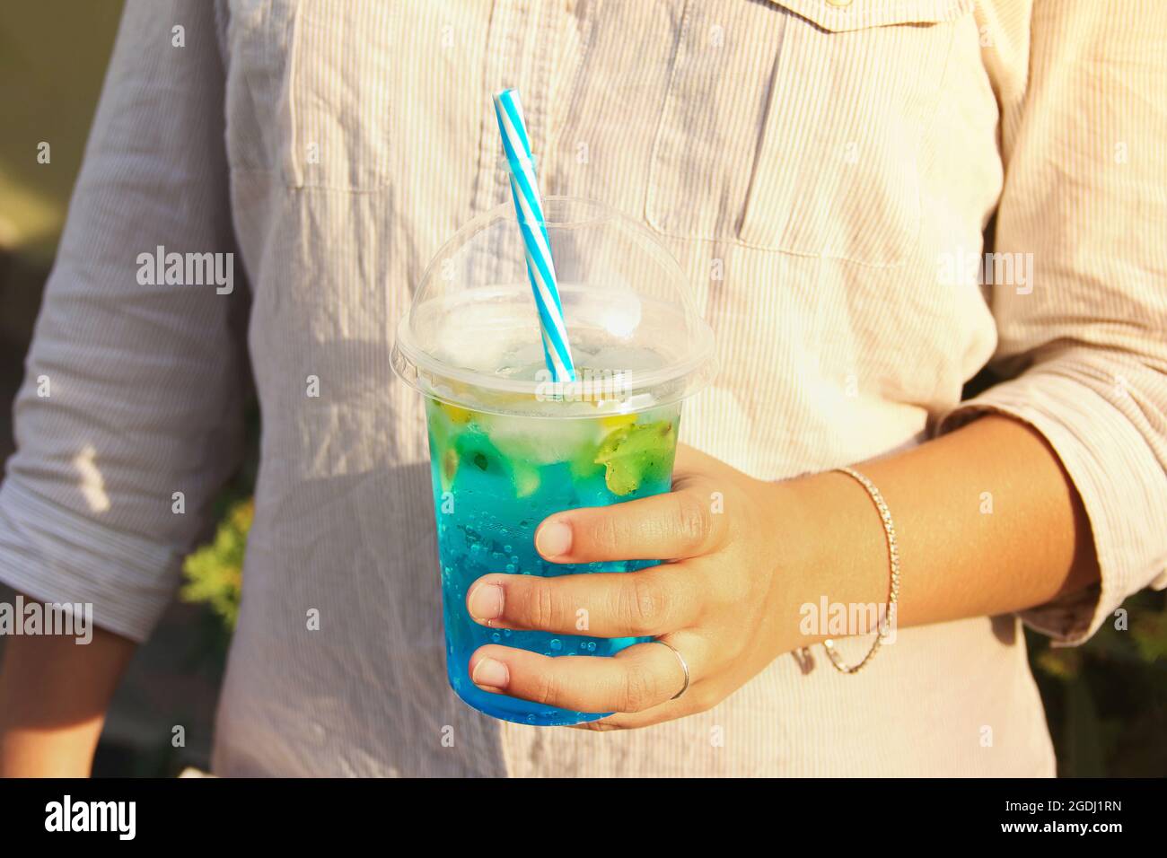 Cocktail in a girl's hand. Juicy drink in the hand Stock Photo - Alamy