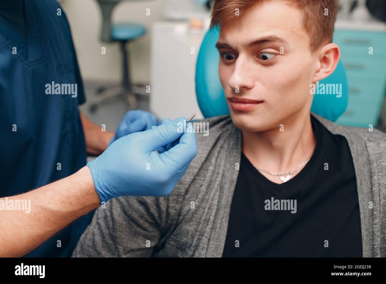 Dentistry. Dentist shows implant to patient of dental clinic Stock ...